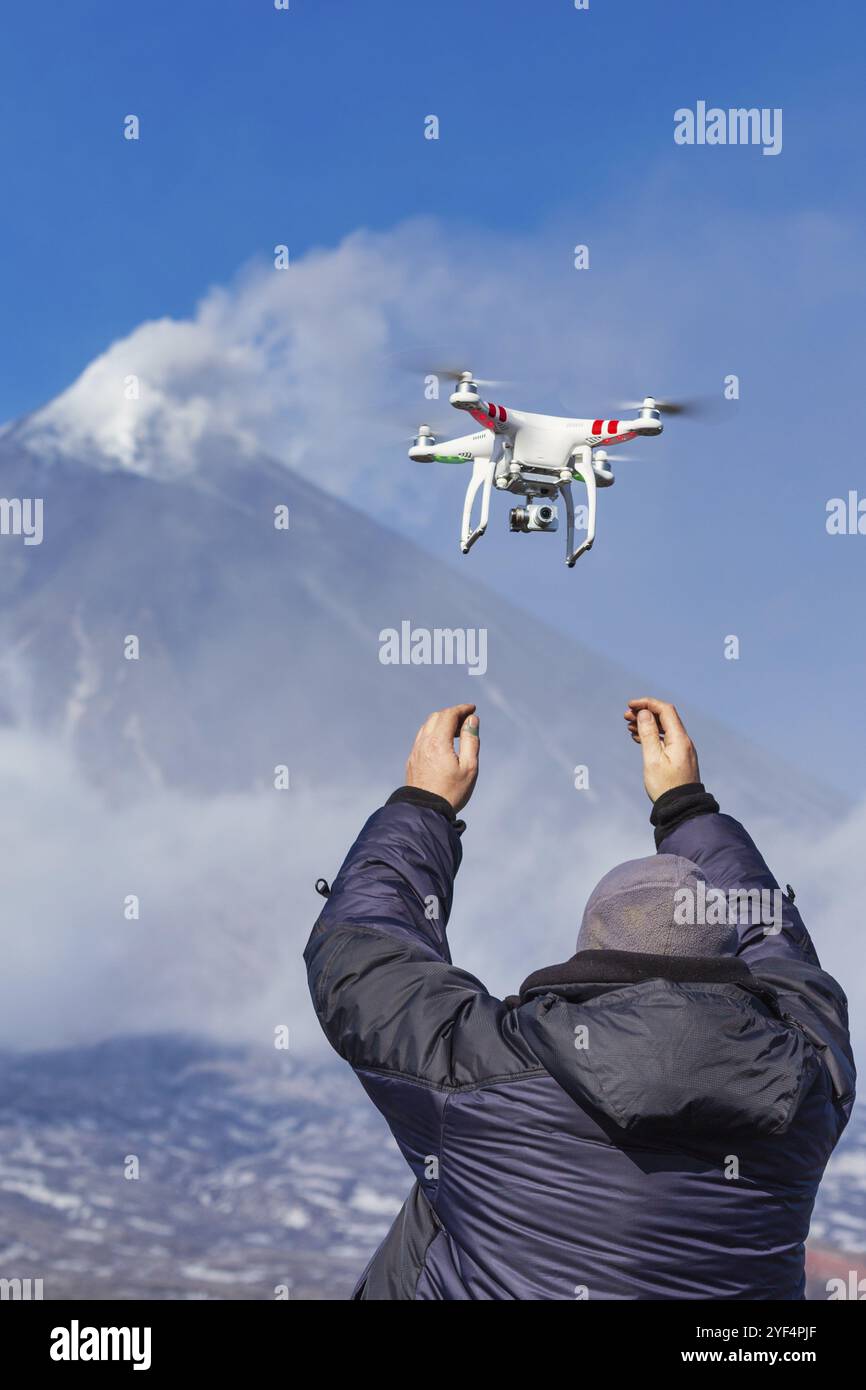 Male launches flying drone quadcopter UAV with digital camera on ...