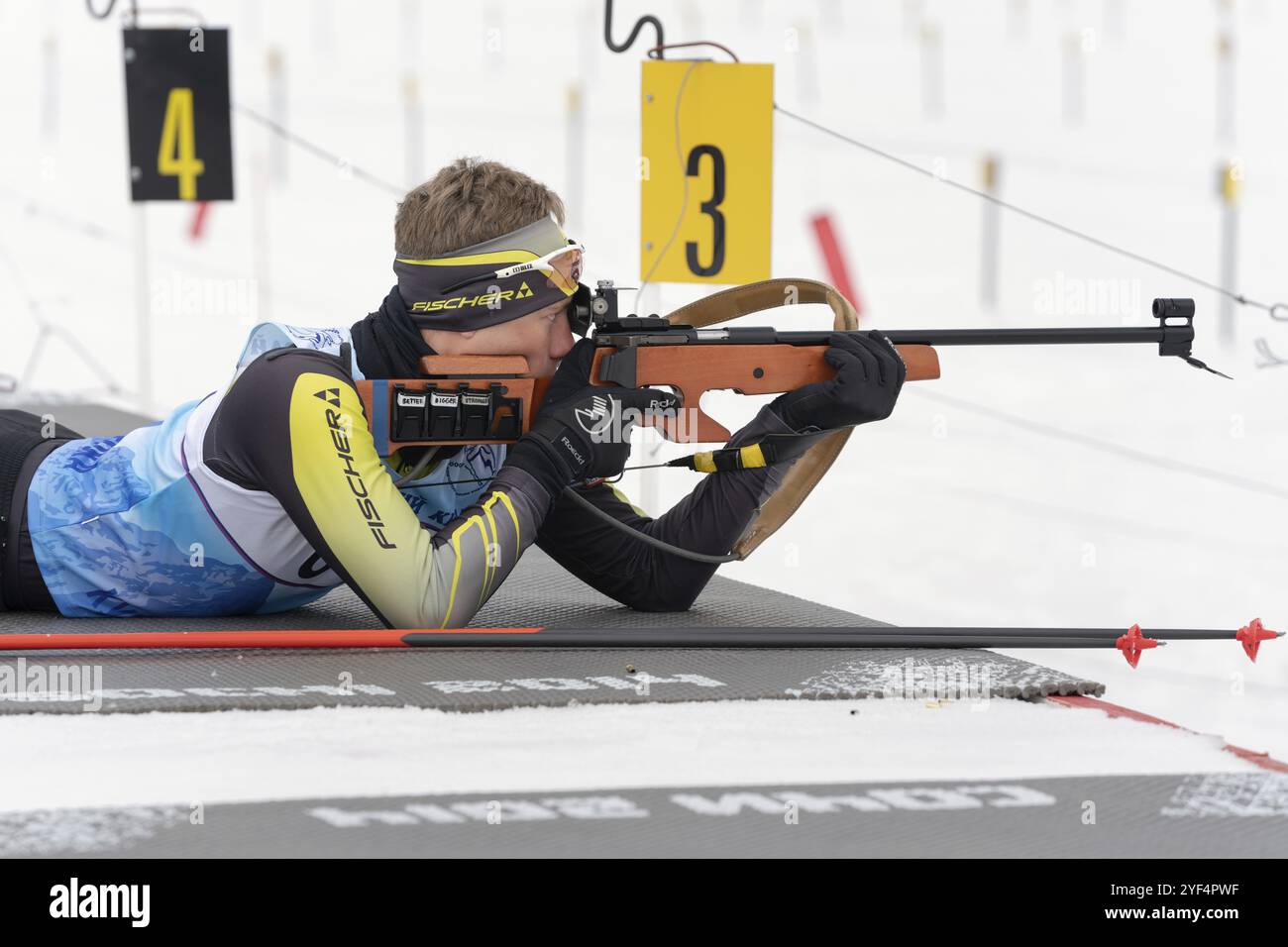 Sportsman biathlete rifle shooting in prone position. Biathlete ...