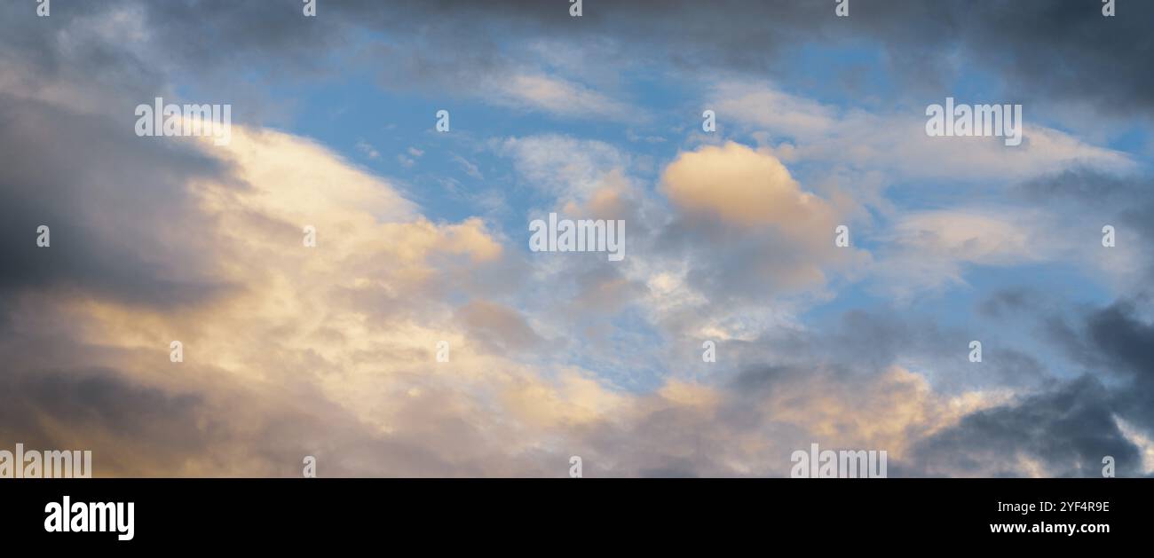 Beautiful colorful panoramic view of summer golden fluffy clouds ...