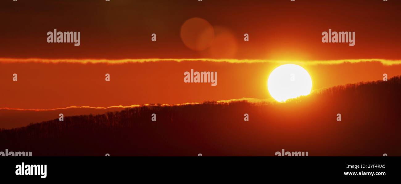 Amazing sunrise in mountains, sunny disk rises from tops of hill ...