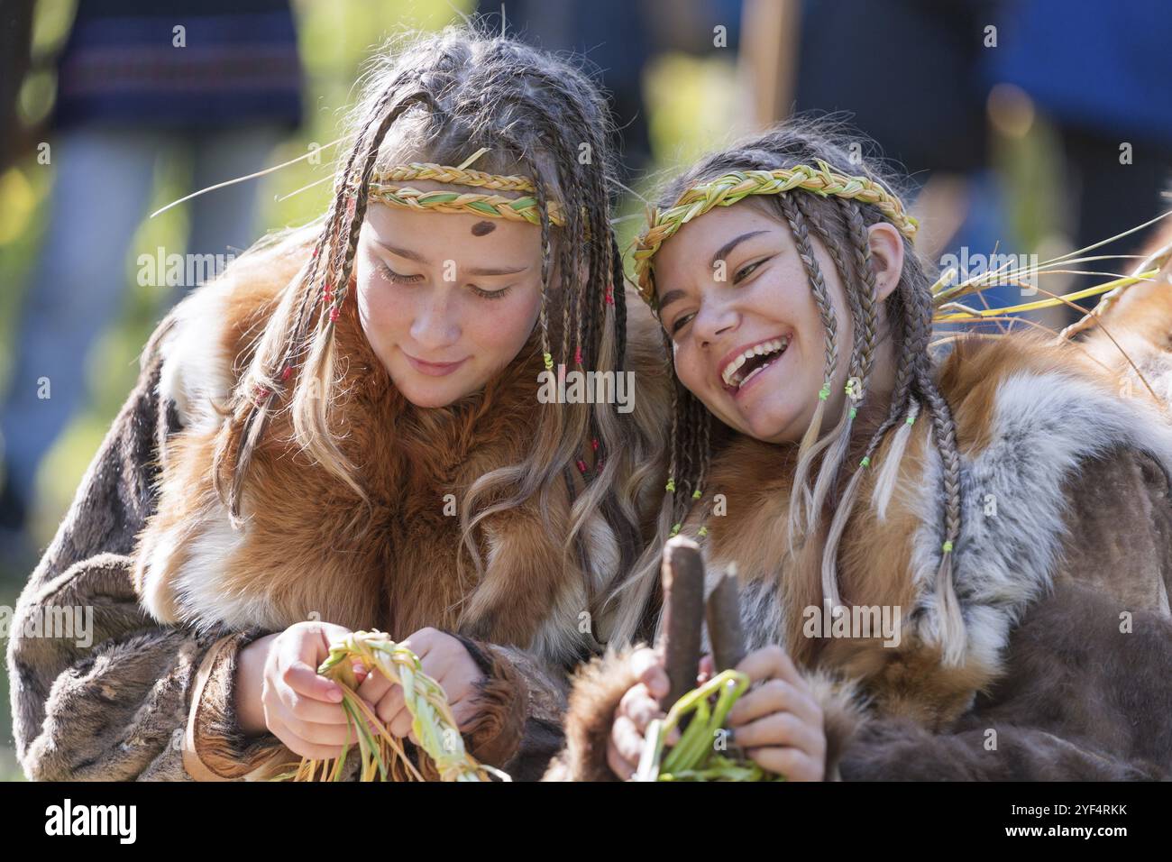 Two smiling girls in traditional clothing aboriginal of Kamchatka ...