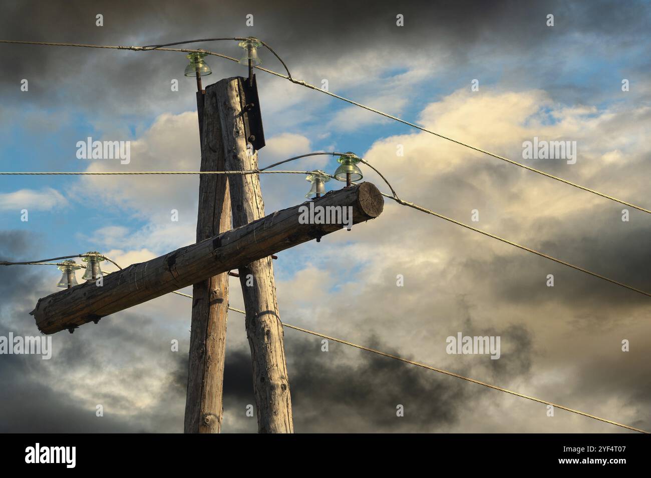 Old electricity pylon cables on wooden poles, high voltage post or high ...