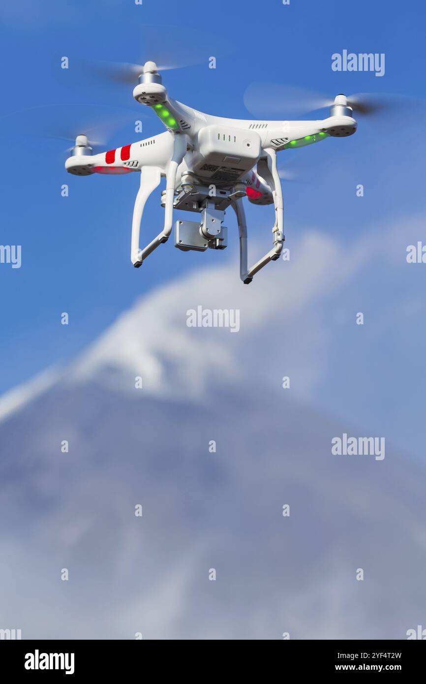 Flying UAV drone quadcopter aerial videography in sky on background ...