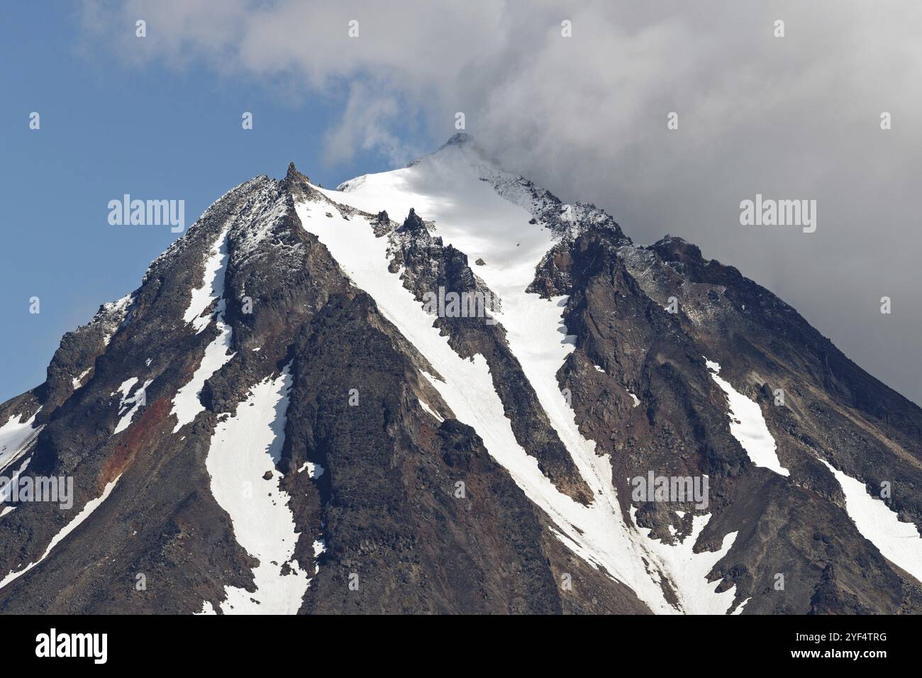 Mountainous landscape of Kamchatka Peninsula: view of top of rocky cone ...