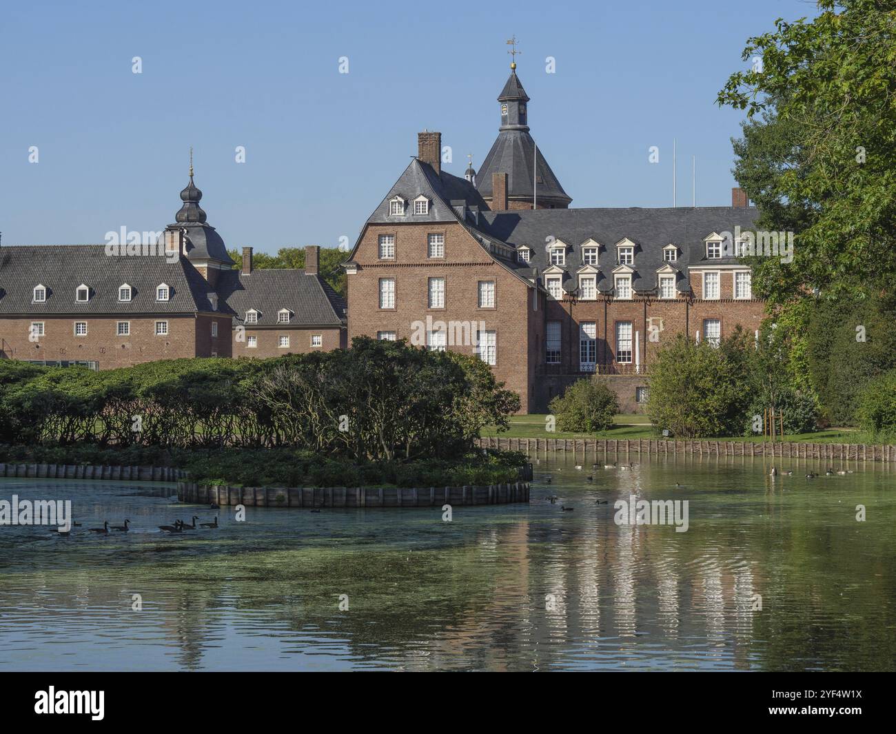 Historic castle by a pond with ducks, surrounded by nature and ...