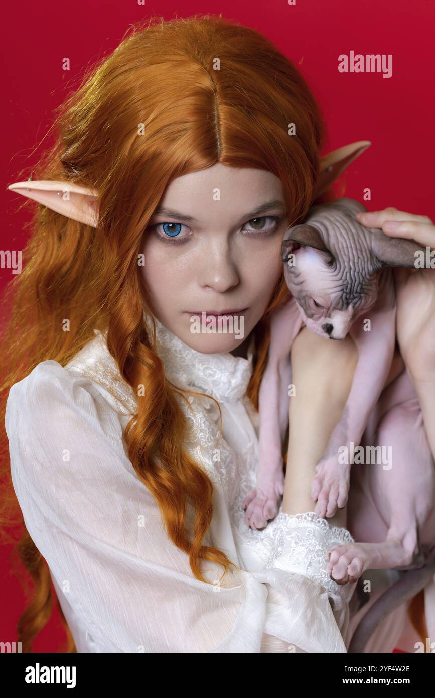 Portrait of ginger young woman cosplayer elf holding in her hands ...