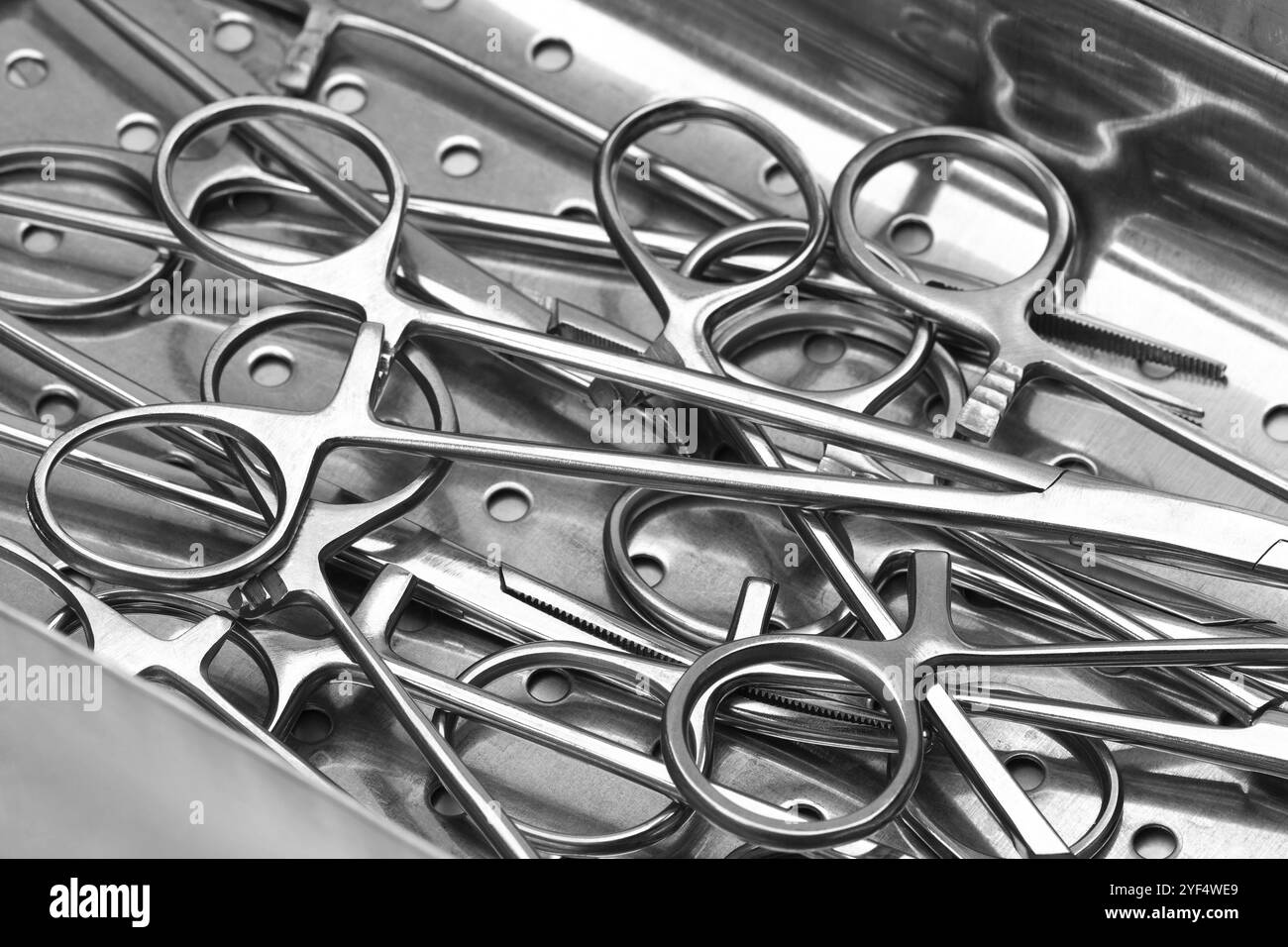Closeup view of stainless surgical needle drivers lying down on steel ...