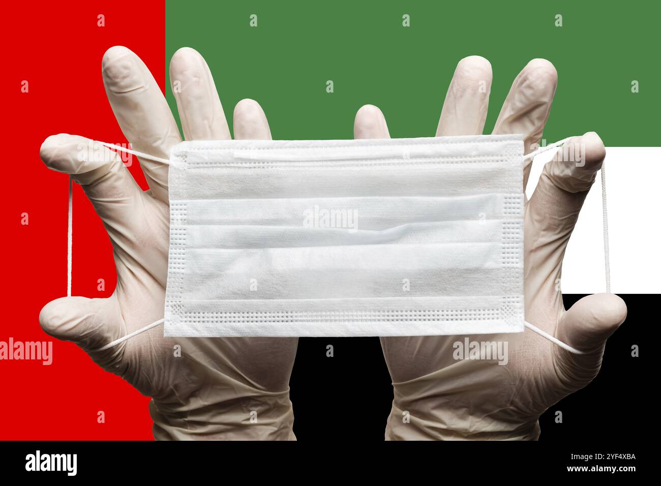 Medic holds protective respiratory face mask in two hands in white ...