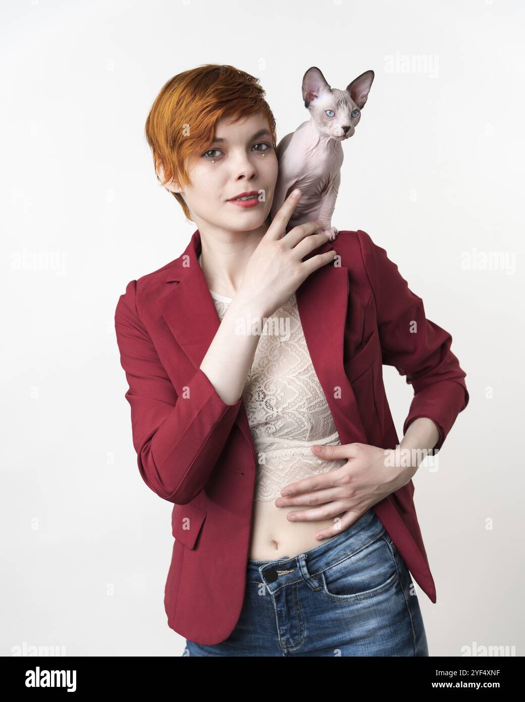 Beautiful hipster redhead young woman looking at camera, dressed in red ...