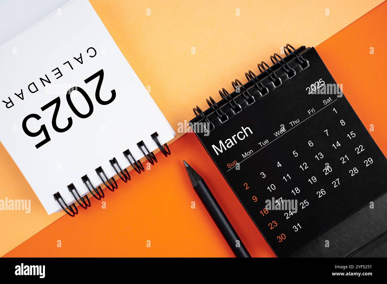 March 2025 desk calendar black and white color with pencil on orange ...