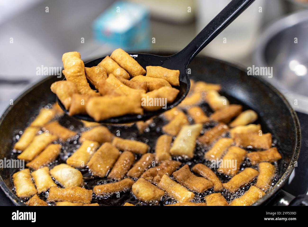 The dough is fried in pieces in a pan in oil (Pa Thong Ko), Baursaks or ...