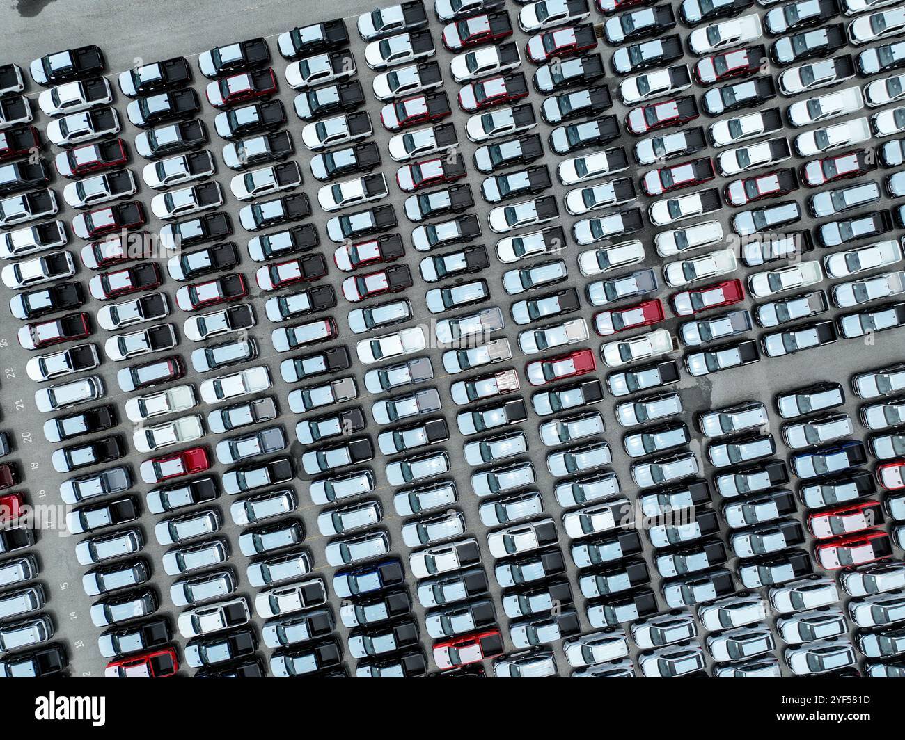 Aerial view of new cars stock at a large factory parking lot ...