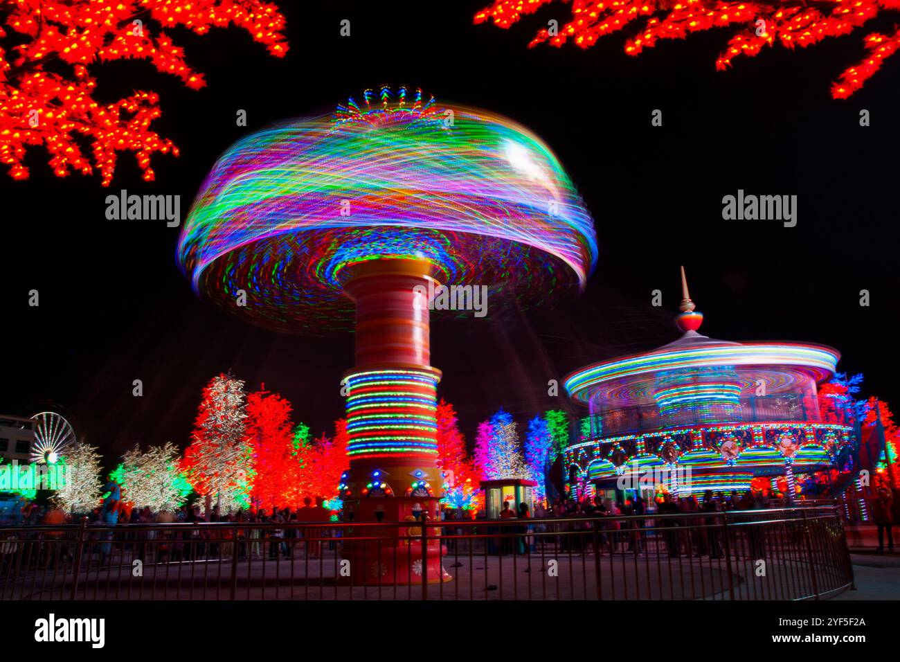 Carnival amusement park ride with swings. Spinning fair ride at night ...