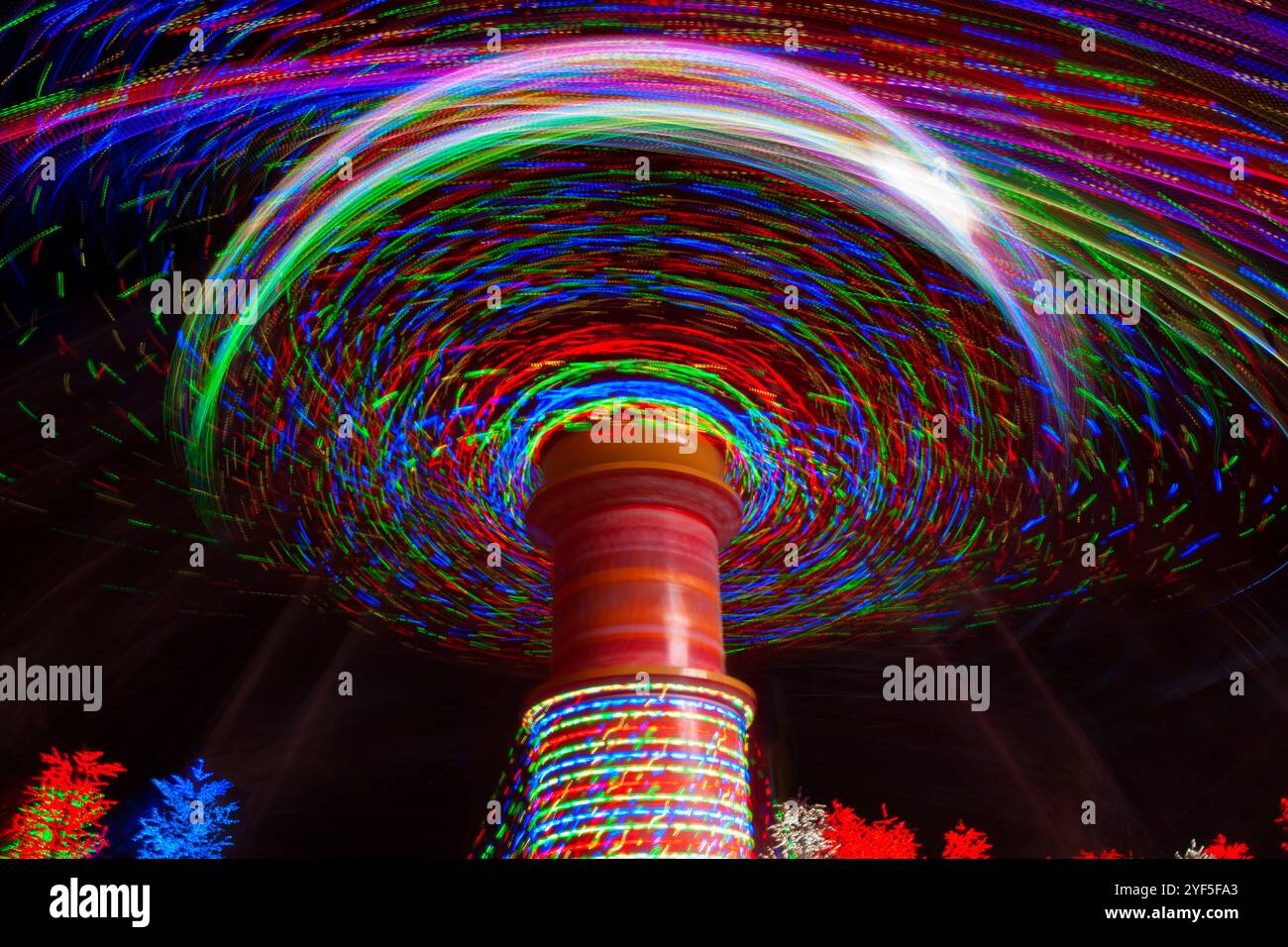 Carnival amusement park ride with swings. Spinning fair ride at night ...