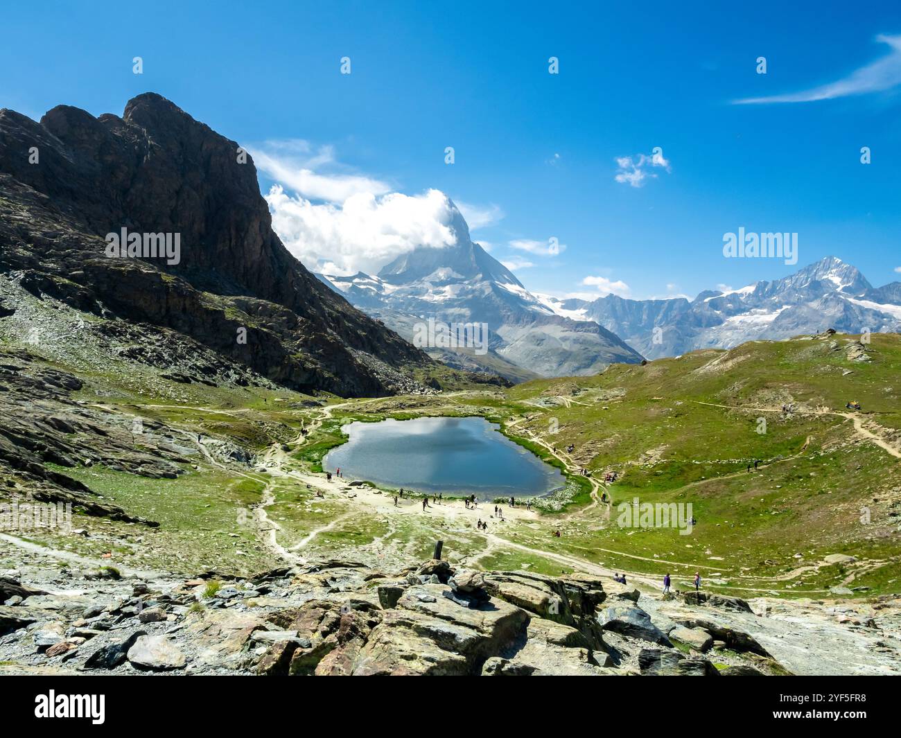 Amazing view of Riffelsee lake near Matterhorn peak mountain with many ...