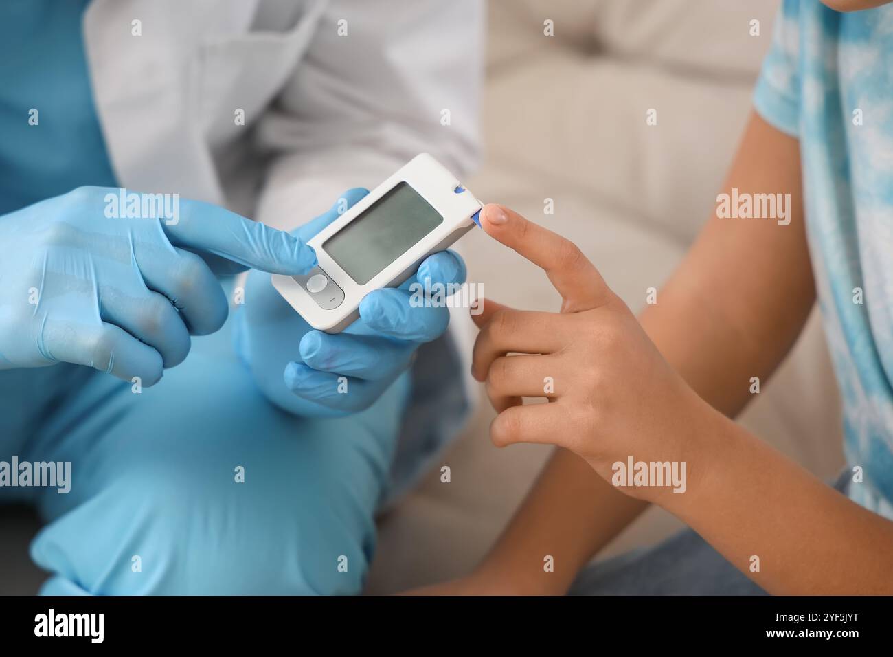 Diabetic girl with doctor using glucometer at home, closeup Stock Photo ...
