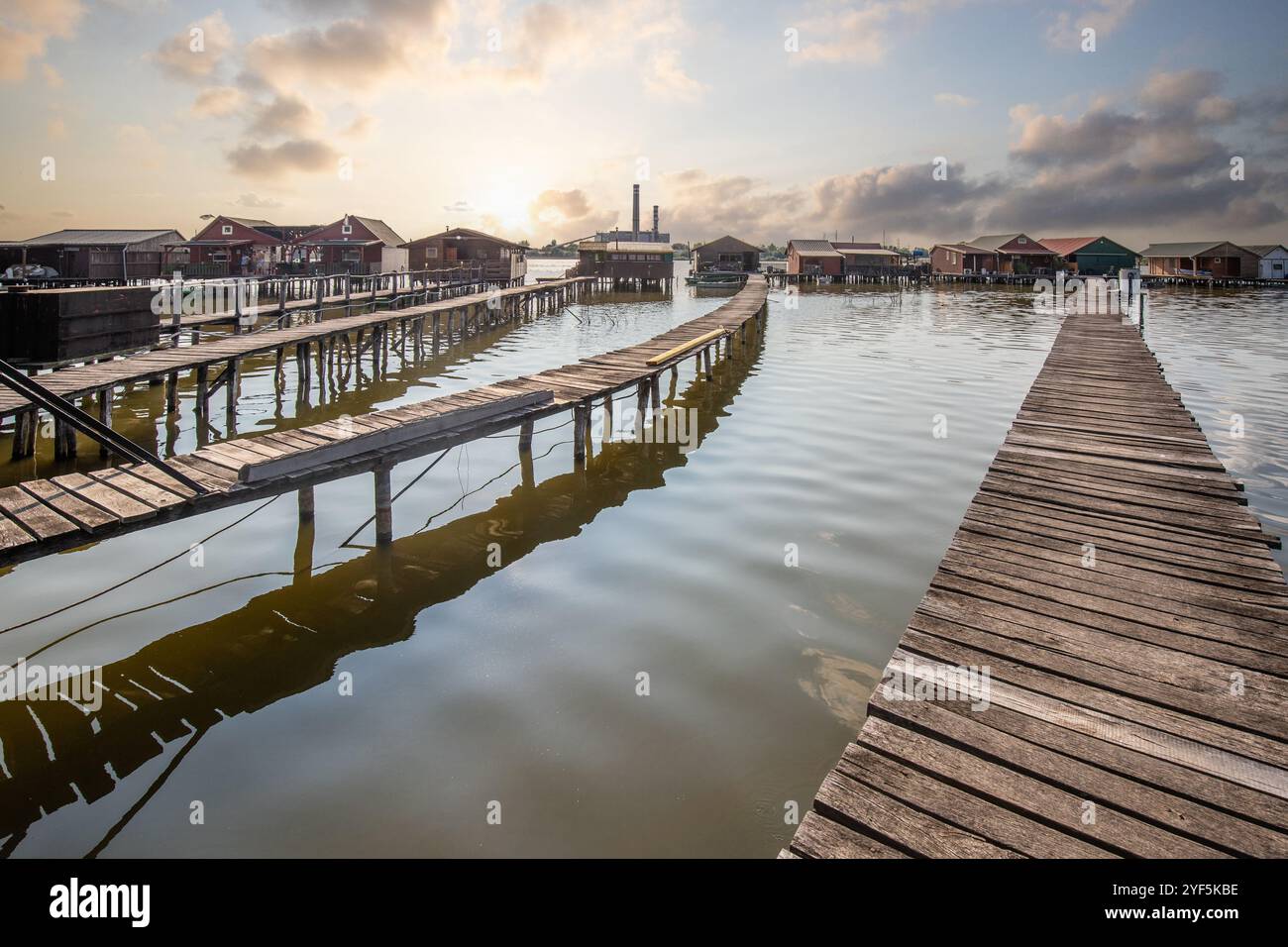 Wooden houses in the water at sunset. Landscape photo of the floating ...