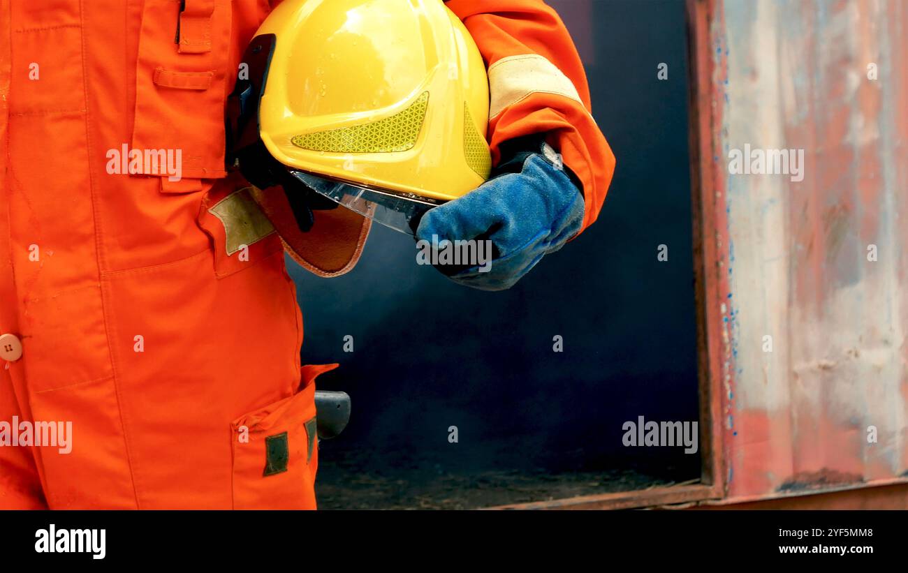 Firefighter fighting with flame using fire hose chemical water foam ...