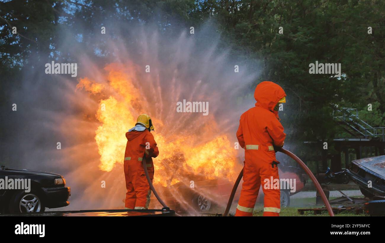 Firefighter fighting with flame using fire hose chemical water foam ...