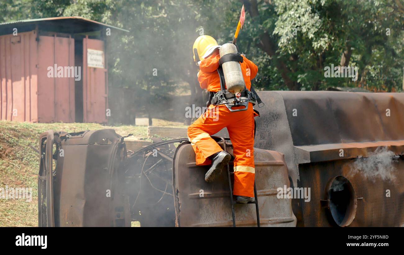 Firefighter fighting with flame using fire hose chemical water foam ...