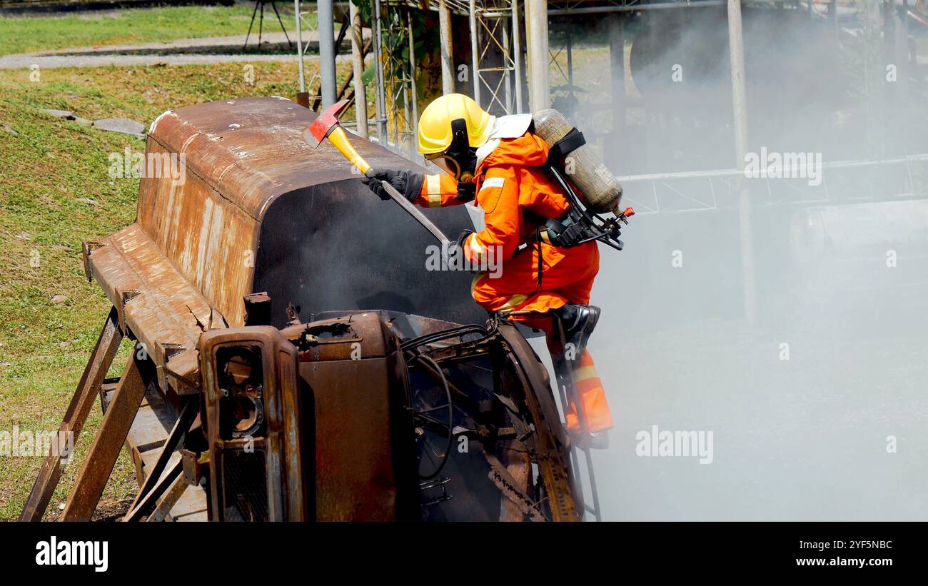 Firefighter fighting with flame using fire hose chemical water foam ...