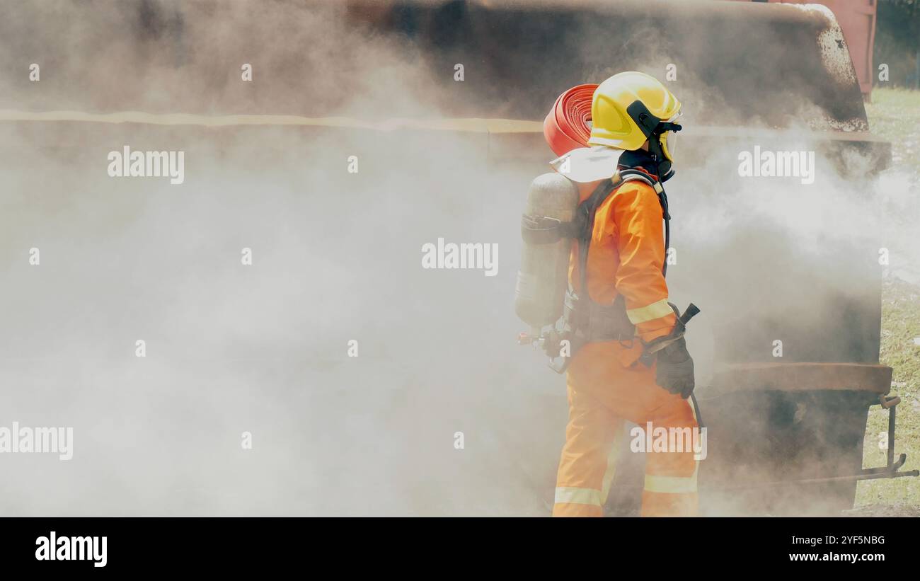 Firefighter fighting with flame using fire hose chemical water foam ...