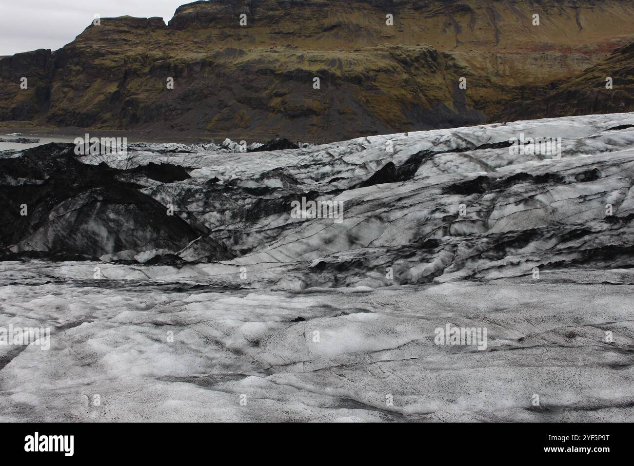 A photograph of the Solheimajokull glacier, Iceland, with black ash ...
