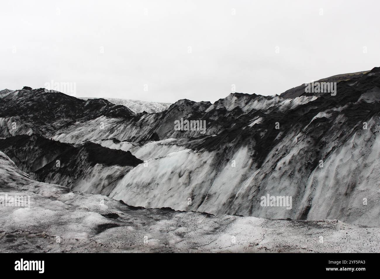A photograph of the Solheimajokull glacier, Iceland, with black ash ...