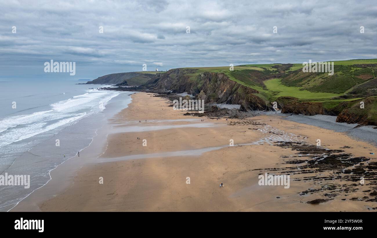 Aerial view of Sandymouth beach with the GCHQ Bude satellite dishes to ...