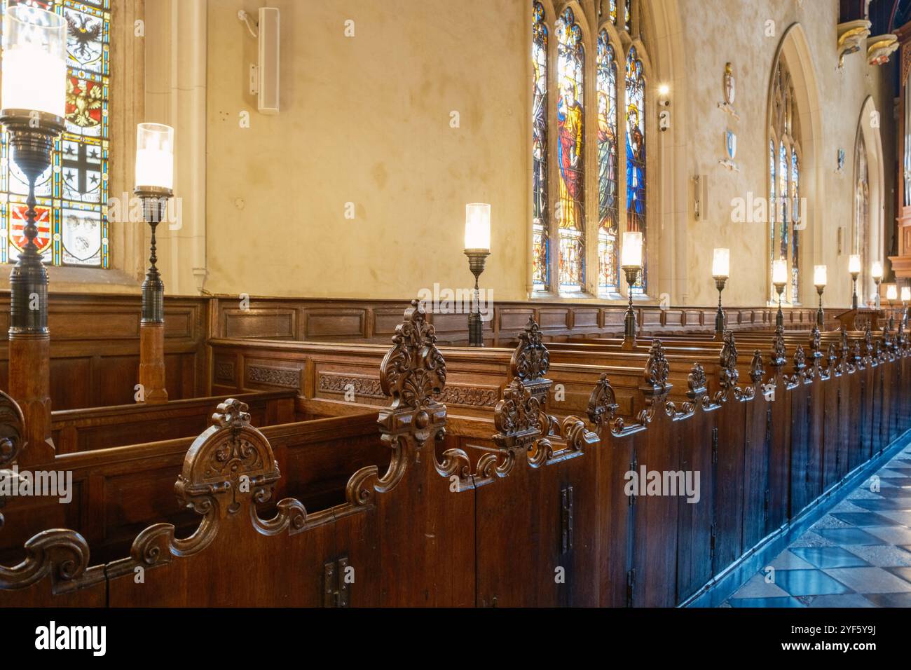 Dark wood pews with intricately carved wooden pew ends and doors at ...