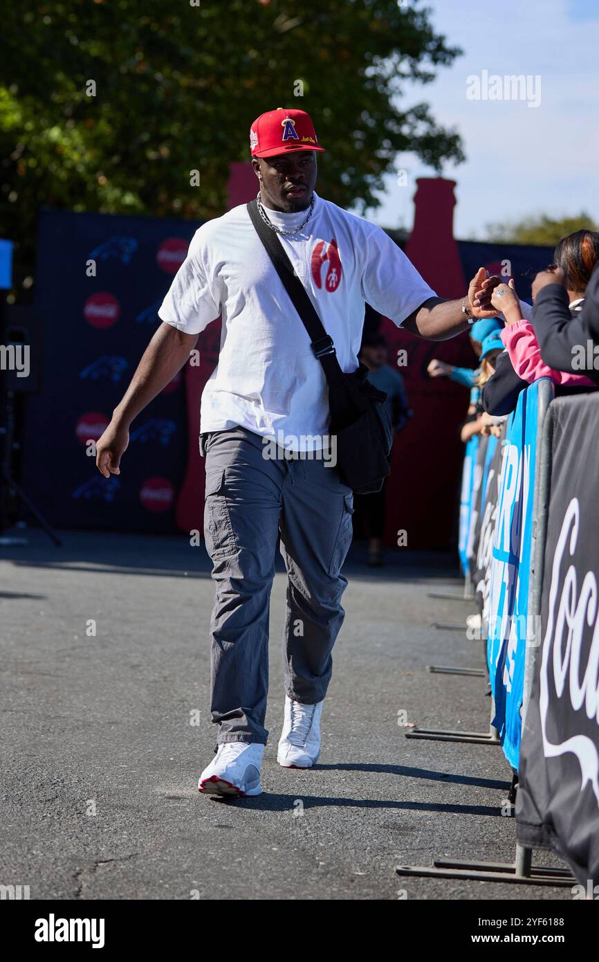 Carolina Panthers linebacker Thomas Incoom bumps fists with fans as he ...