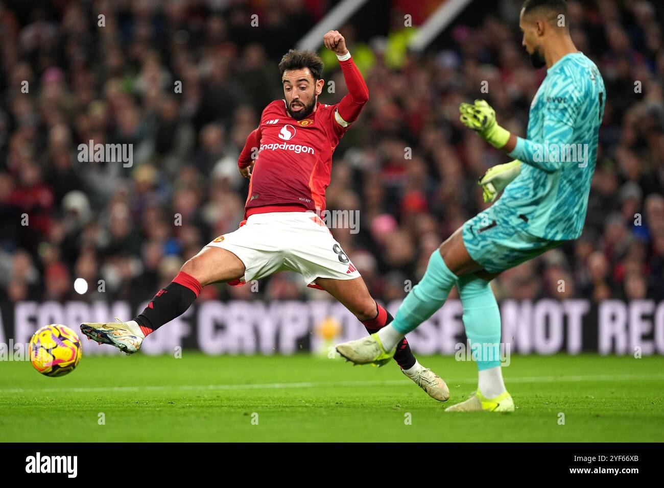 Manchester United's Bruno Fernandes (left) attempts to stop a ball from ...