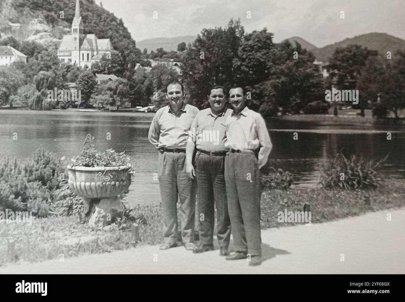 Bled, Slovenia, Yugoslavia - 1956: Three men posing in front of a Bled ...