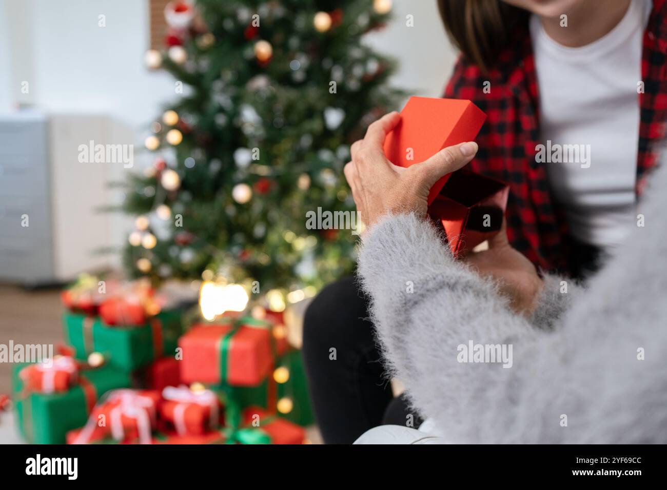 Mother open gifts by daughter gave at hone in Christmas day. Christmas ...