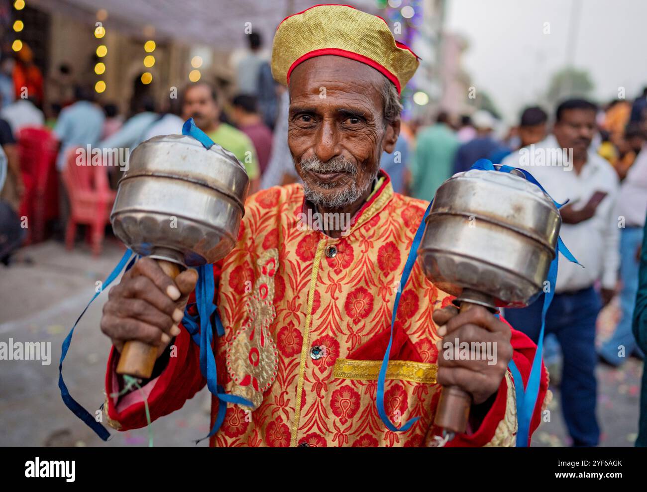 An Indian brass band member performs in a religious procession during ...