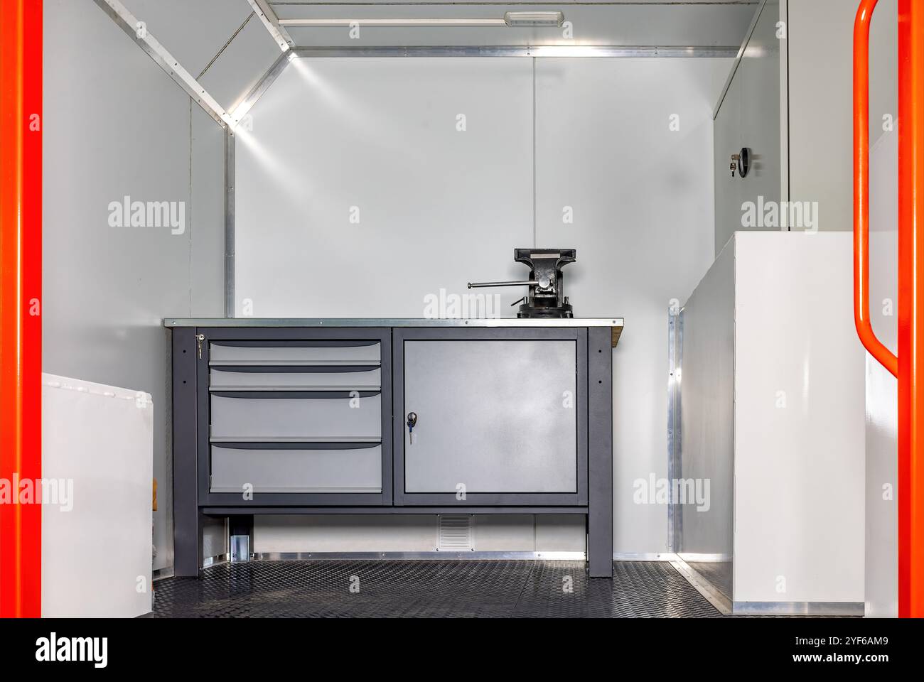 Interior of a modern truck-based mobile workshop with a gray workbench, elegant design ...