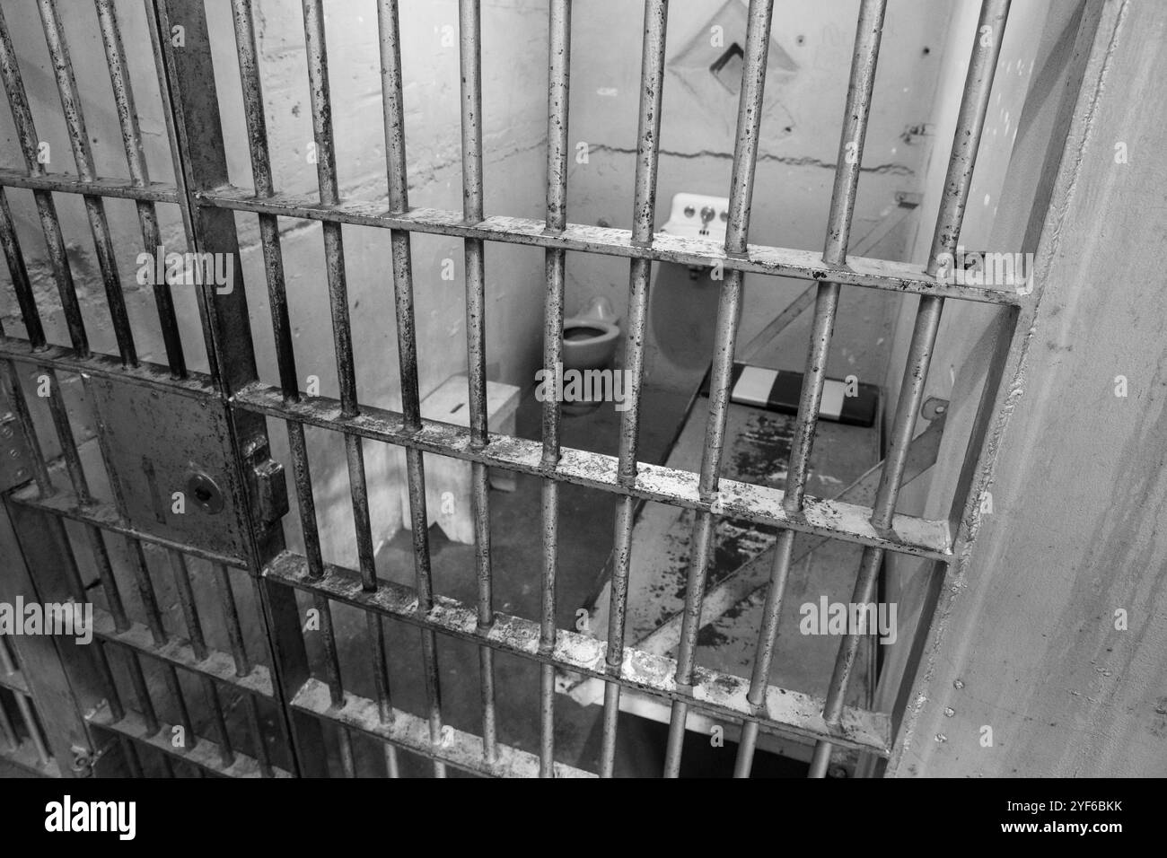 Desolate Prison Cell Interior Captured in Black and White Stock Photo ...
