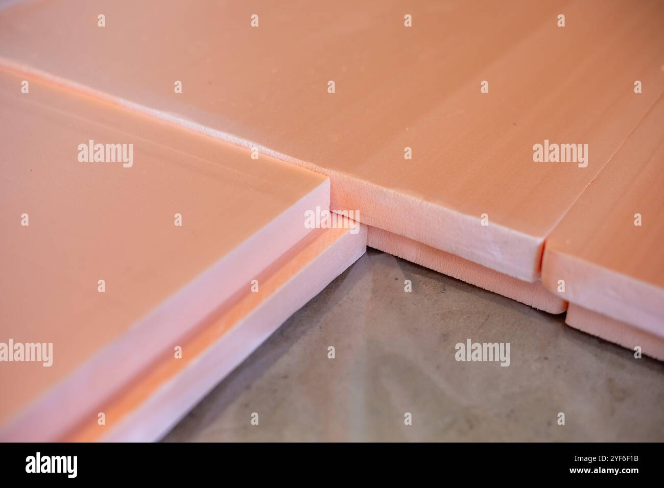 Laying polystyrene foam on the floor. Locking of slabs. Thermal ...