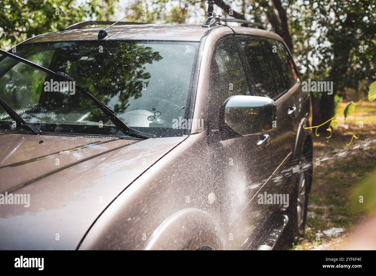 Washing your SUV car with a hose at home in your backyard Stock Photo ...