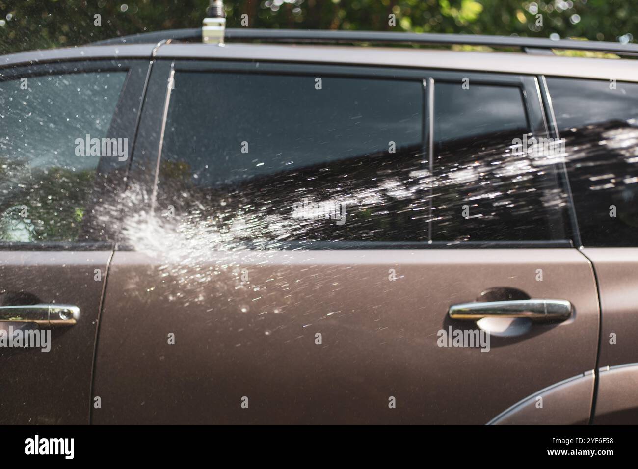 Washing your SUV car with a hose at home in your backyard Stock Photo ...