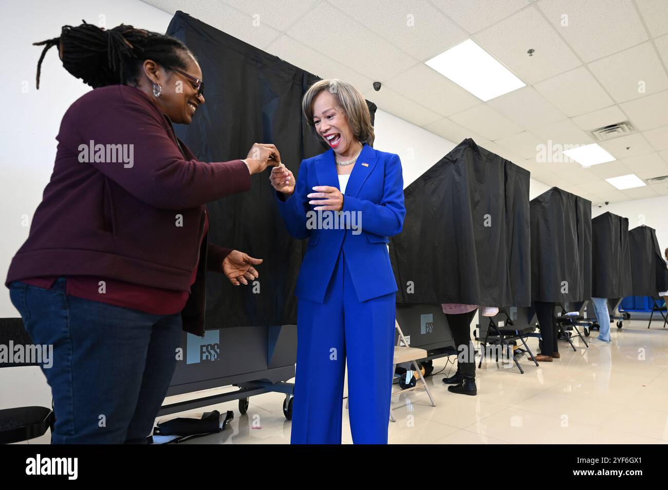 Rep. Lisa Blunt Rochester, D-Del, right, receives a sticker from Tracey ...