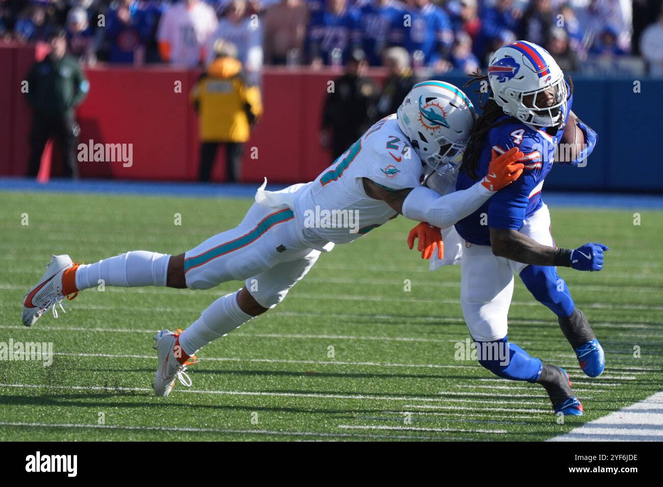 Buffalo Bills running back James Cook (4) is pushed out of bounds by ...