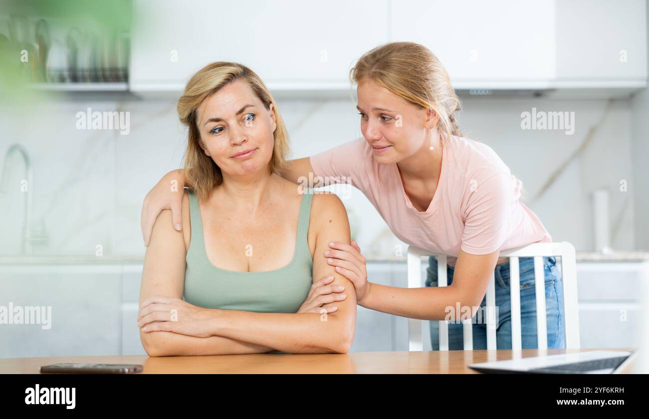 Teenage daughter asking mother to forgive after argument Stock Photo ...