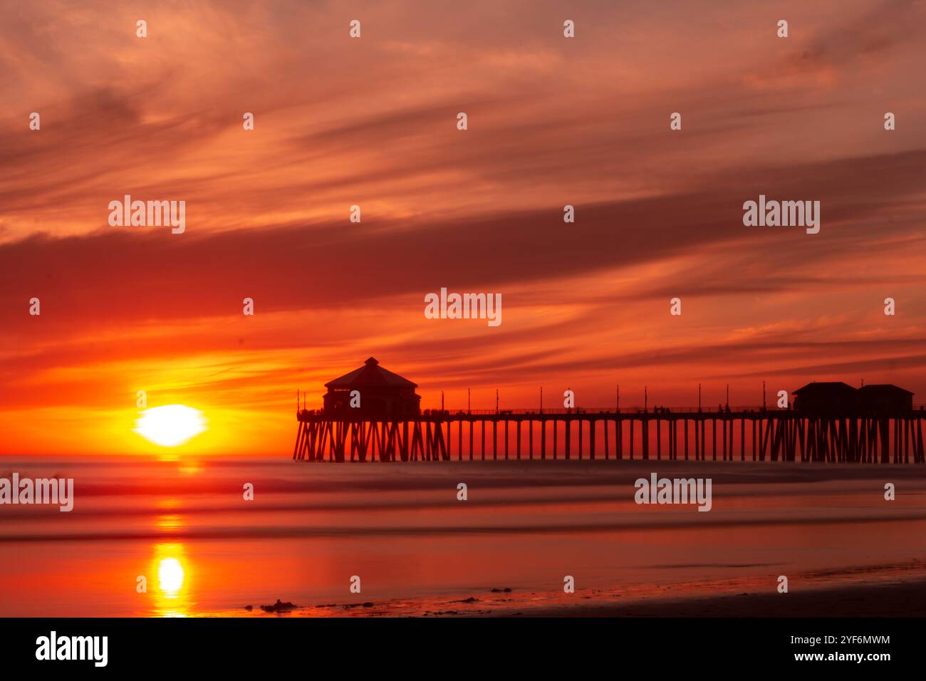 A view of the Huntington Beach Pier during sunset Stock Photo - Alamy