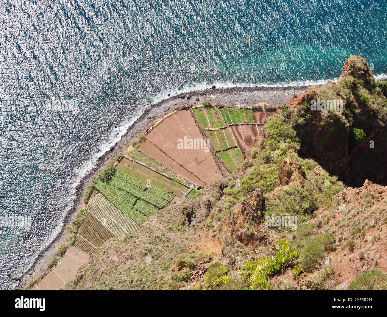 Aerial view captures terraced farmland at the edge of a steep cliff ...