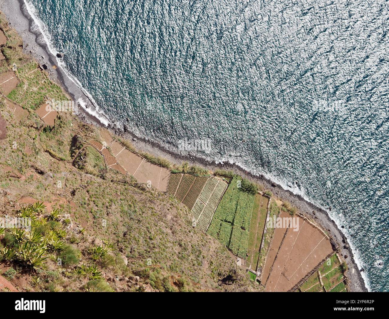Aerial view captures terraced farmland at the edge of a steep cliff ...
