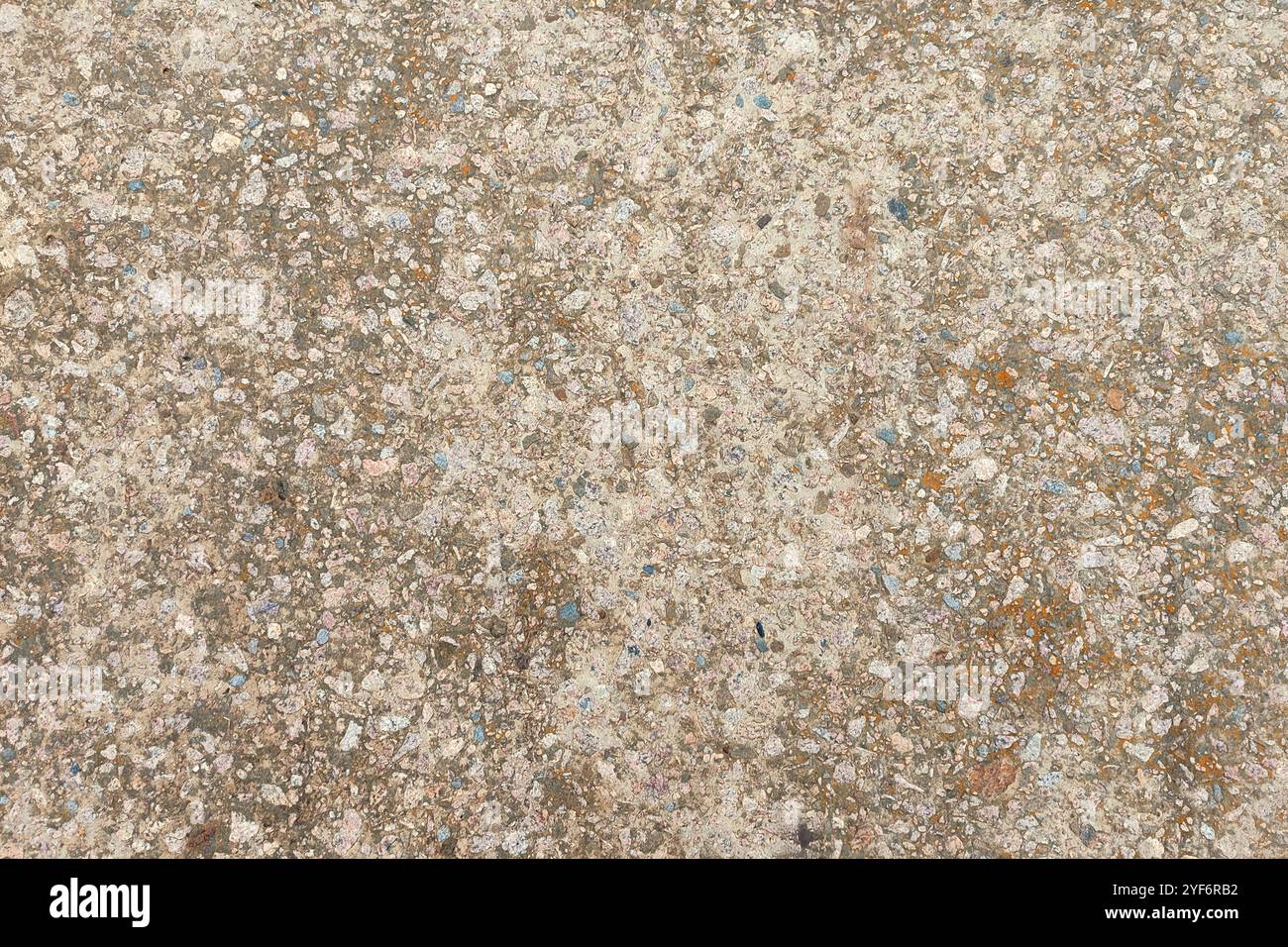 Concrete texture. Pebbles of different colors and signs of aging are ...