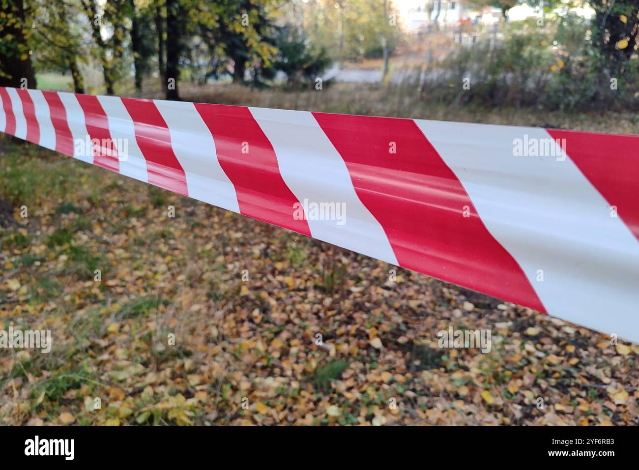 Red and white lines of barrier fencing tape. Fencing red and white tape ...