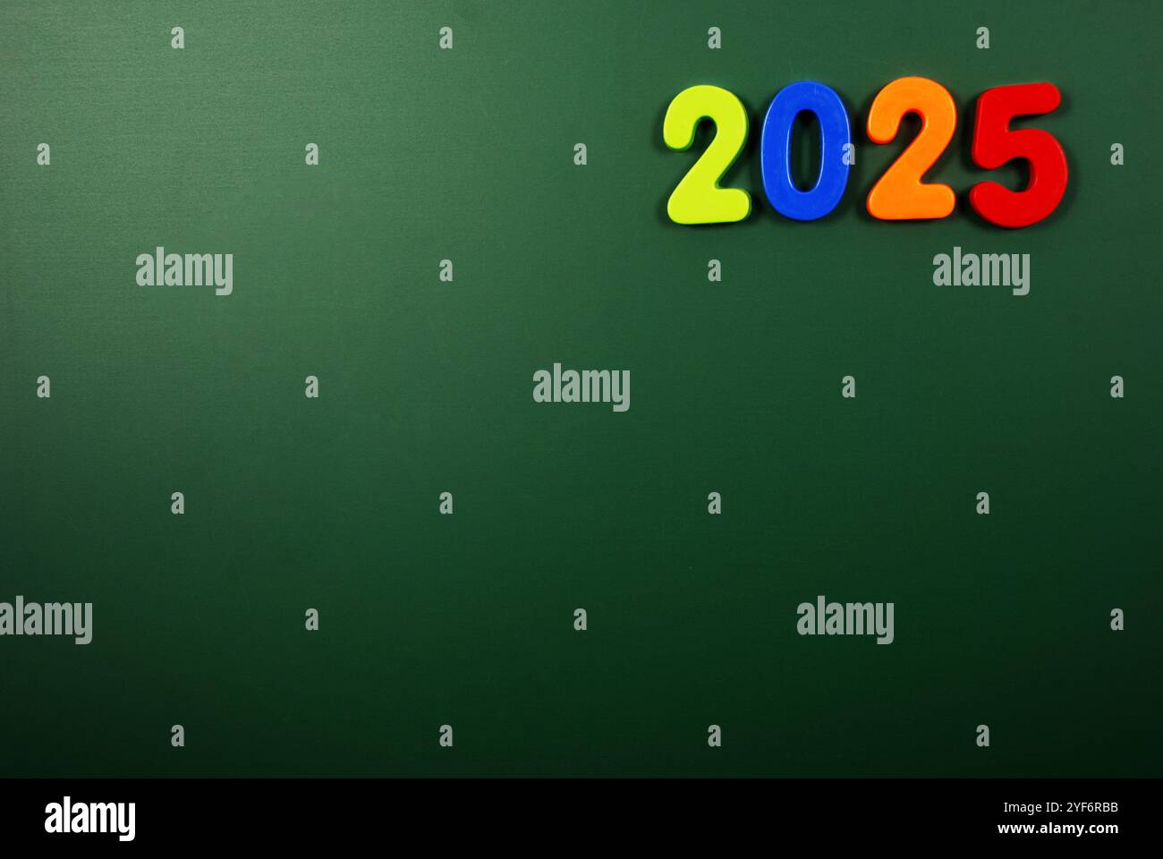 2025 year written in bright plastic magnetic letters stuck on a ...