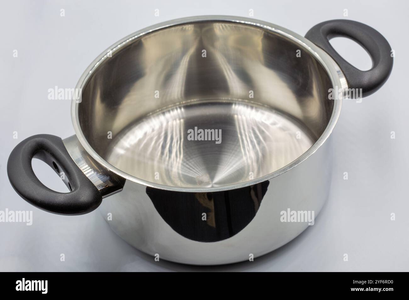 Studio shoot of large shiny stainless steel empty new saucepan closeup ...